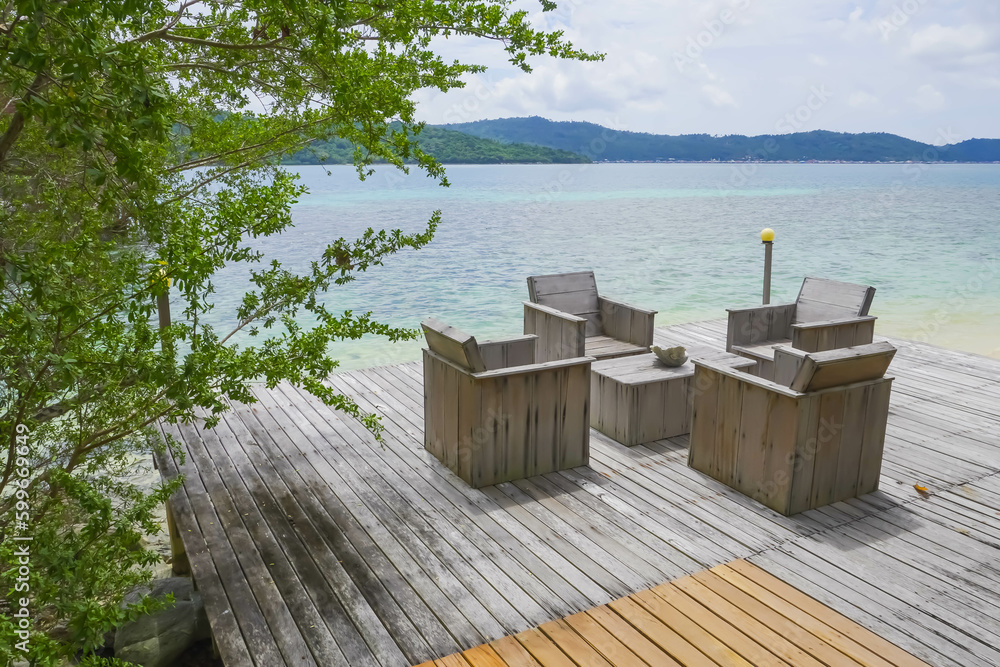 Simple outdoor hotel or resort courtyard with brown wooden sofa ...