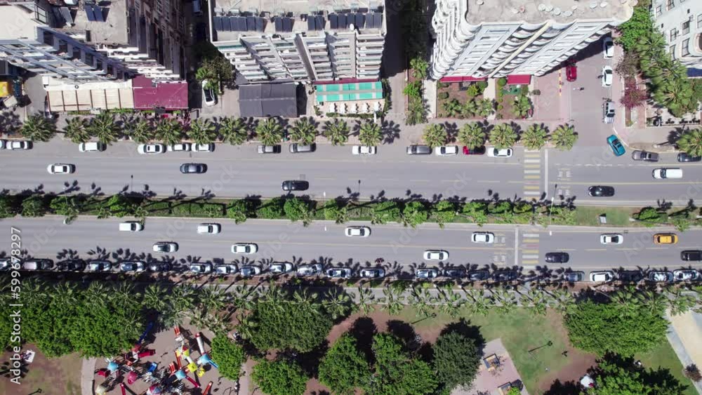 Cars driving on avenue of seaside city. Traffic on seaside city street ...