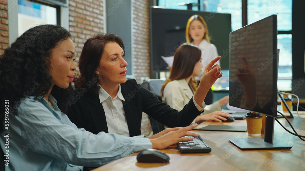 Female programmer is hard at work in her office, diligently coding her project while ...
