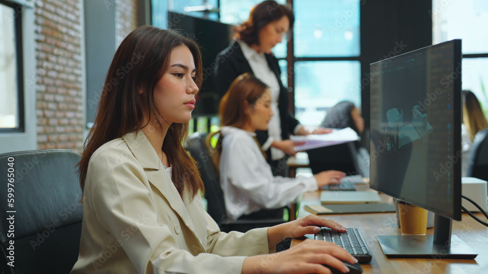 Female designer using computer to design ev car prototype at office ...