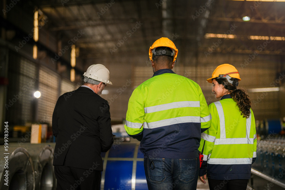 team of engineers checking control heavy machine in factory. Senior ...