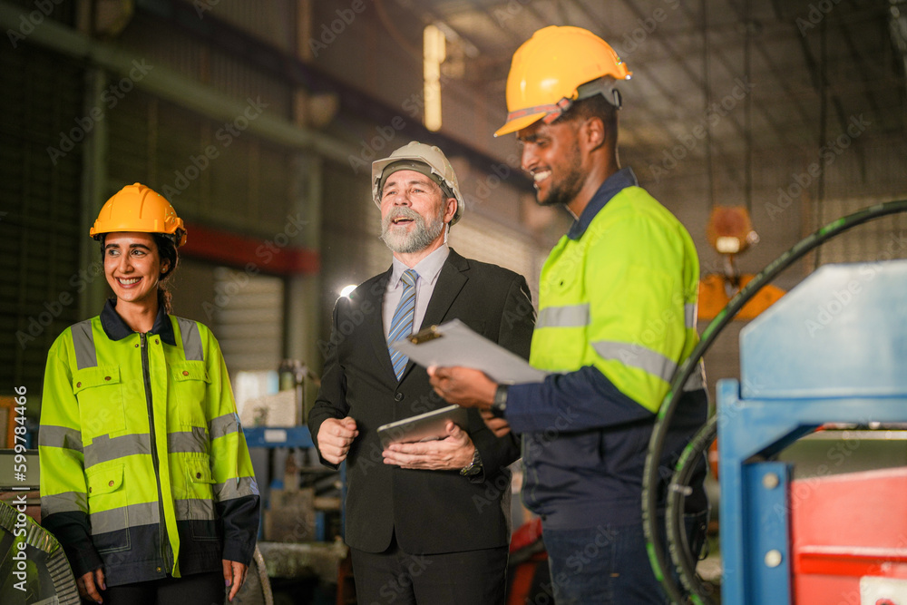 team of engineers checking control heavy machine in factory. Senior ...