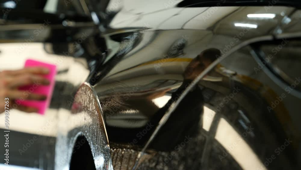 Close up to PPF installation process on a front headlight and hood. PPF ...