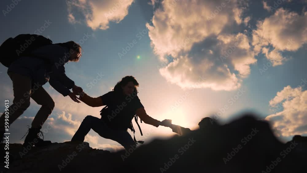 Helping hand in teamwork.Group of climbers daring climb to victory ...