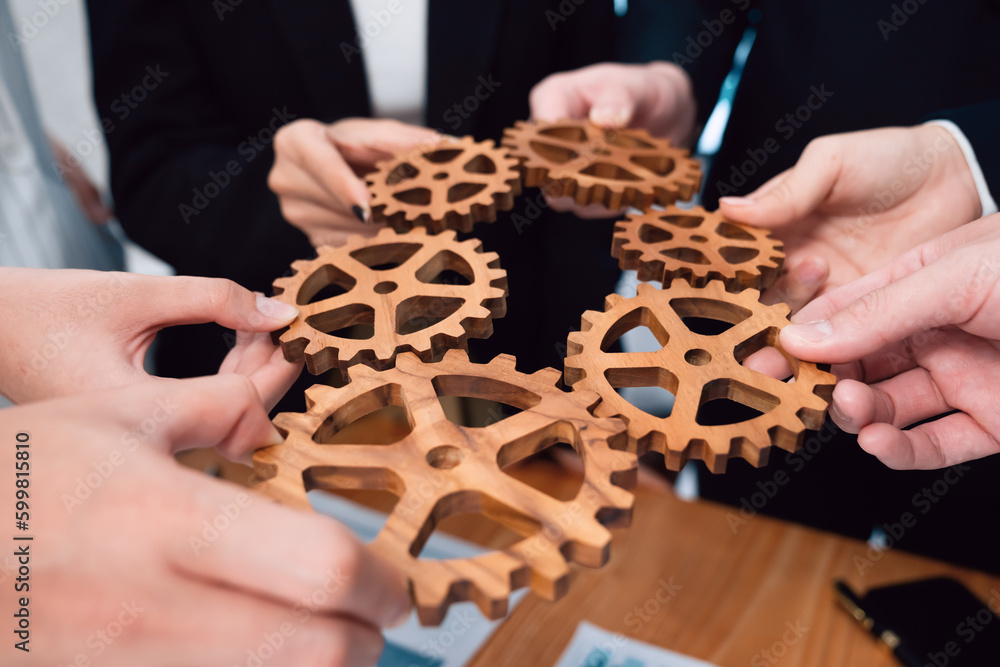 Closeup top view businesspeople hand holding gear and join together ...