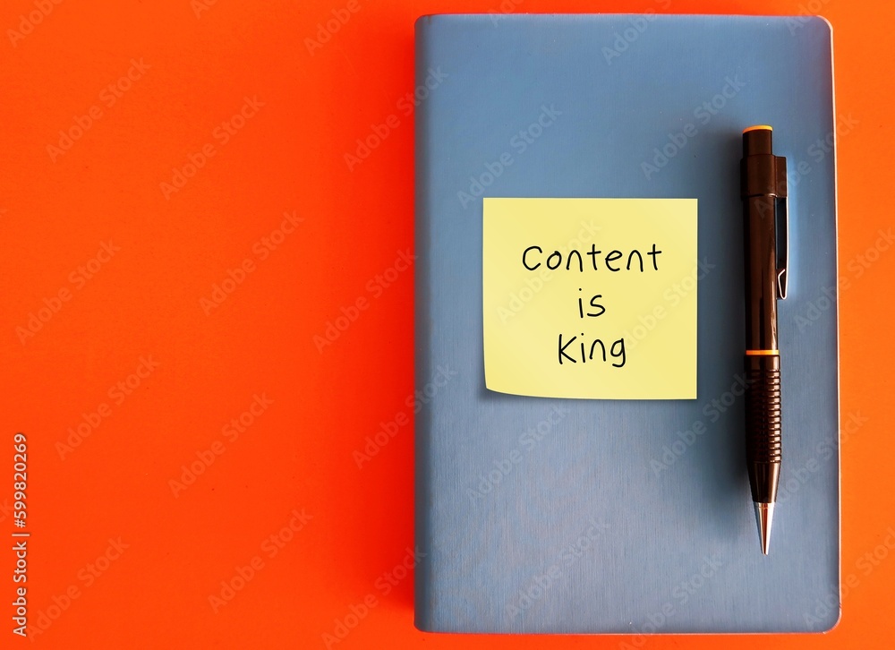 Blue notebook on orange copy space background with handwritten note ...