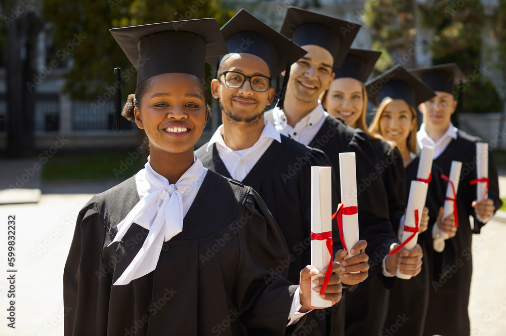 Outdoor portrait of happy diverse university students on graduation day ...