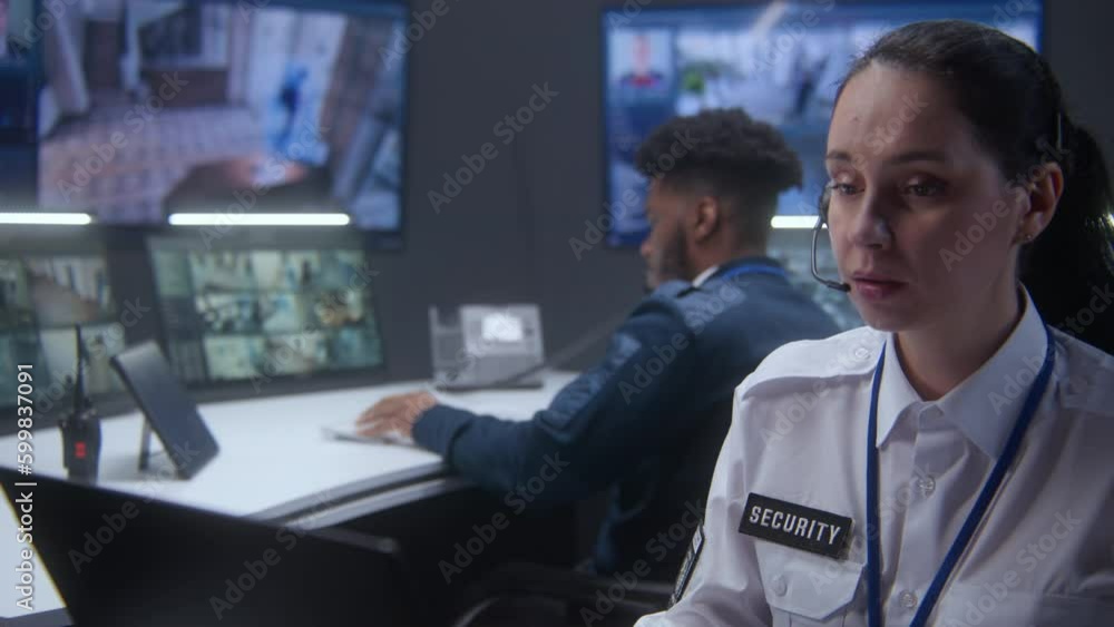 Video Stock African American security officer talks with colleague uses ...