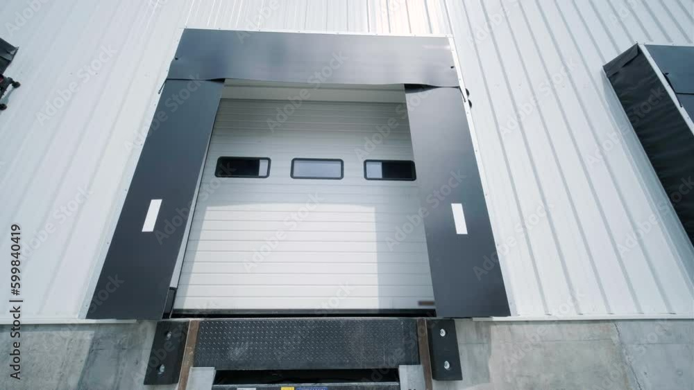 There are automatic gates at a large warehouse. The gates are used for ...