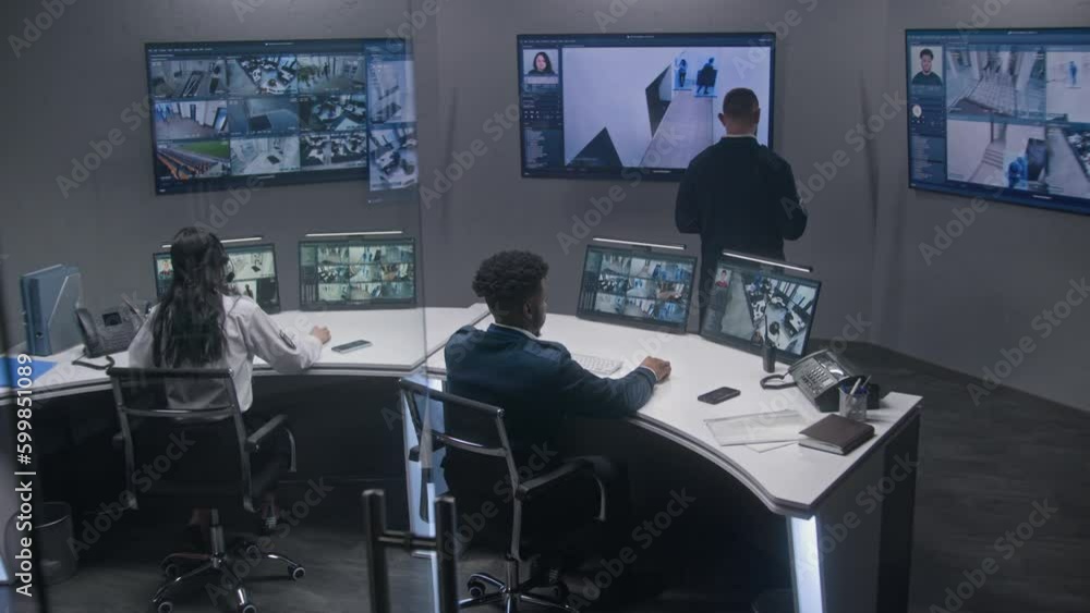 Multi ethnic security officers monitor CCTV cameras with AI face ...