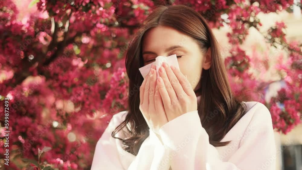 Portrait of allergic unhealthy sick young dark haired woman sneezing in ...