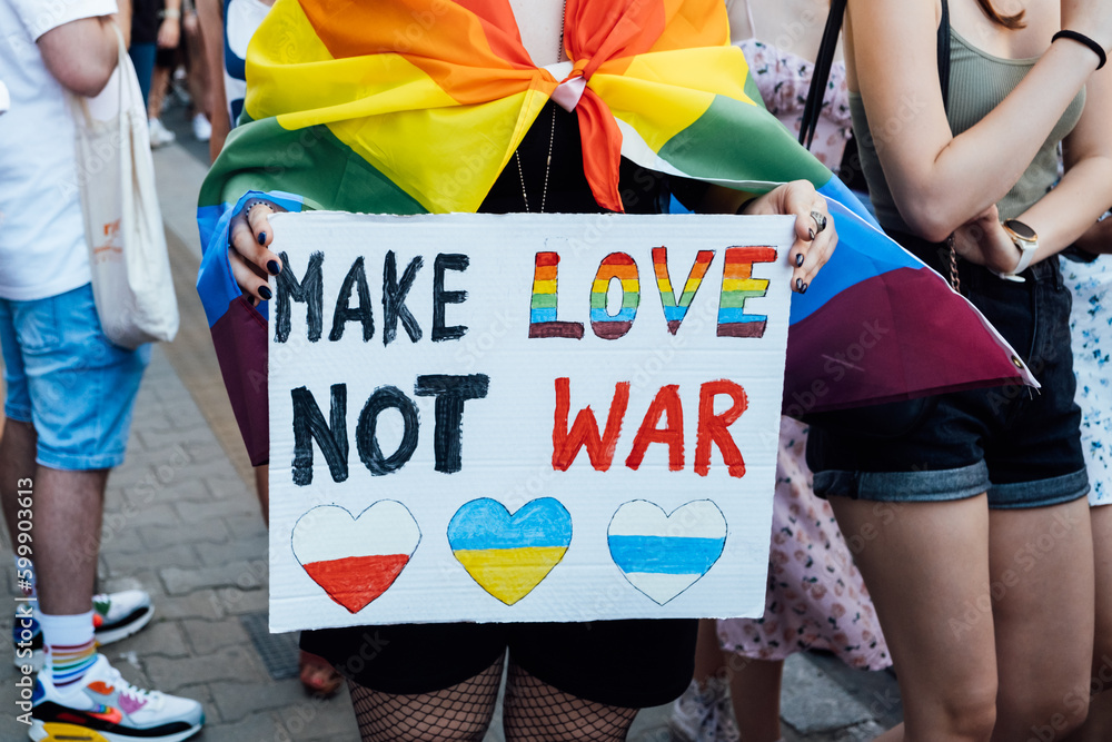 Gay pride, LGBTQ solidarity march with rainbow flags and antiwar ...