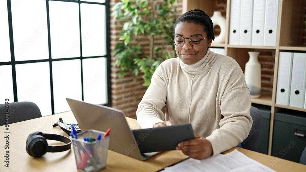 African american woman business worker using touchpad and laptop at ...