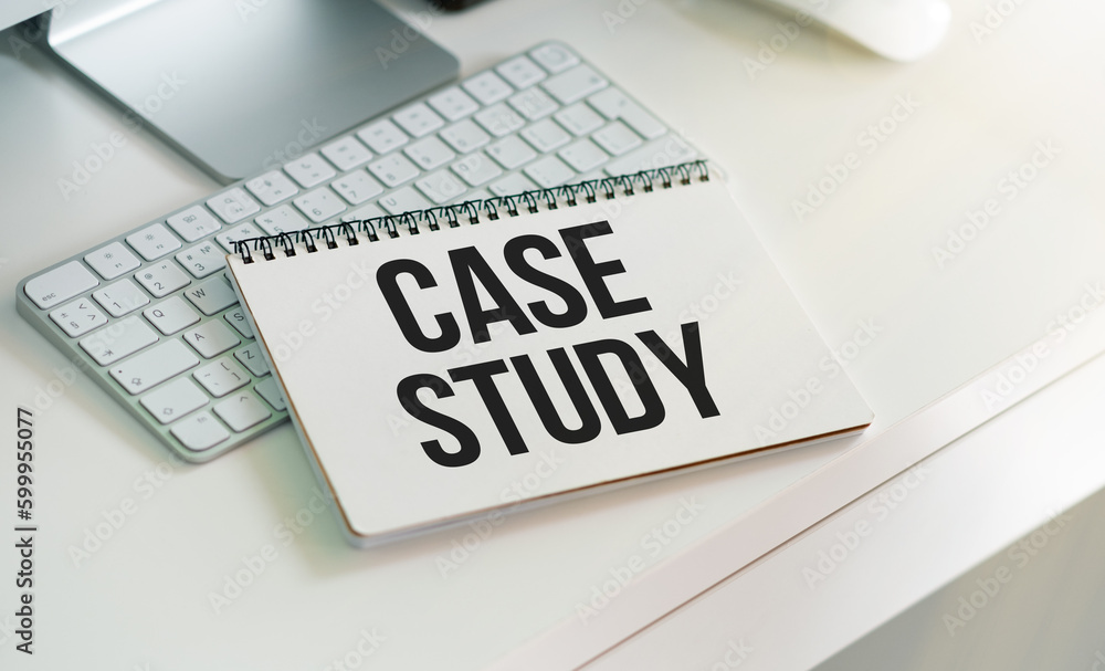 Card with case study text on a white background with office items ...