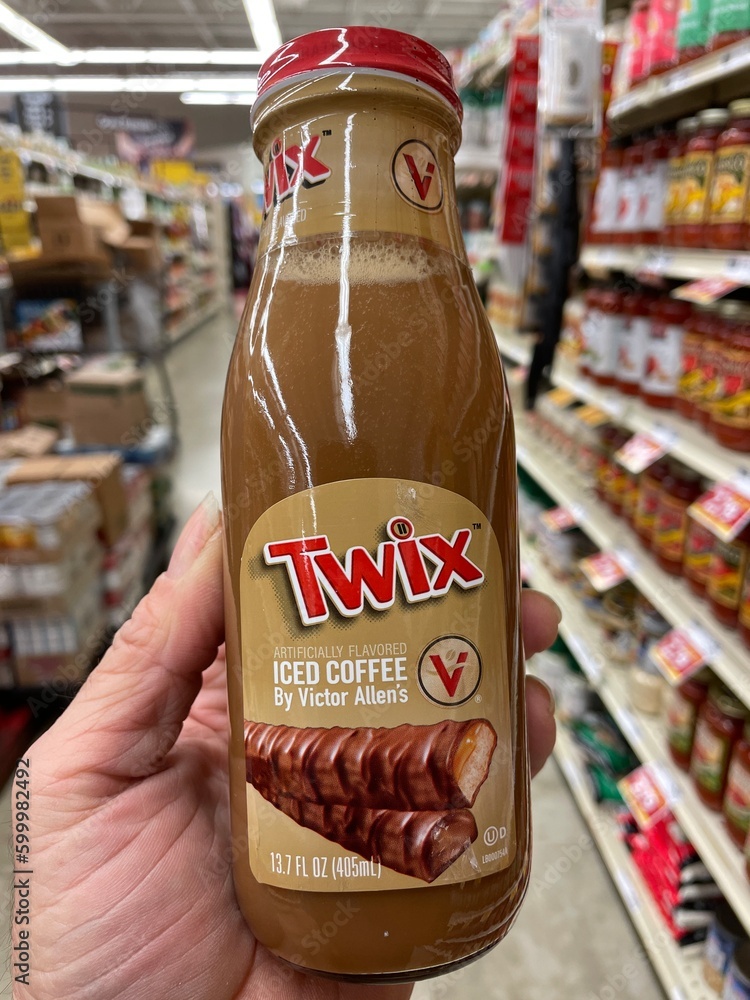 Grocery store hand holding Twix iced coffee Stock Photo | Adobe Stock