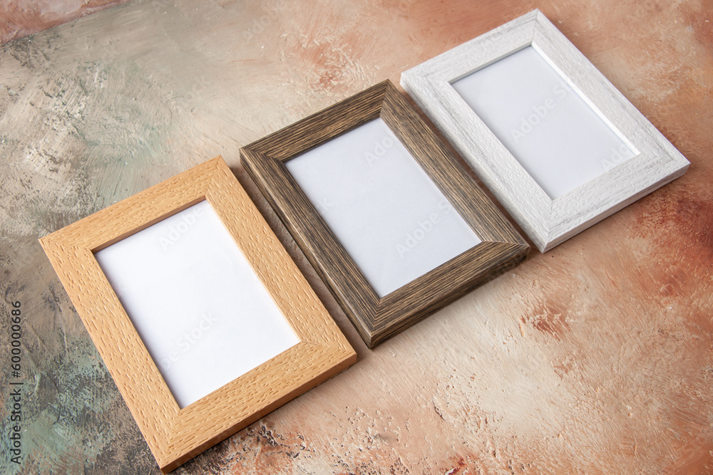 Side view of three wooden photo frames in different sizes hung on side ...
