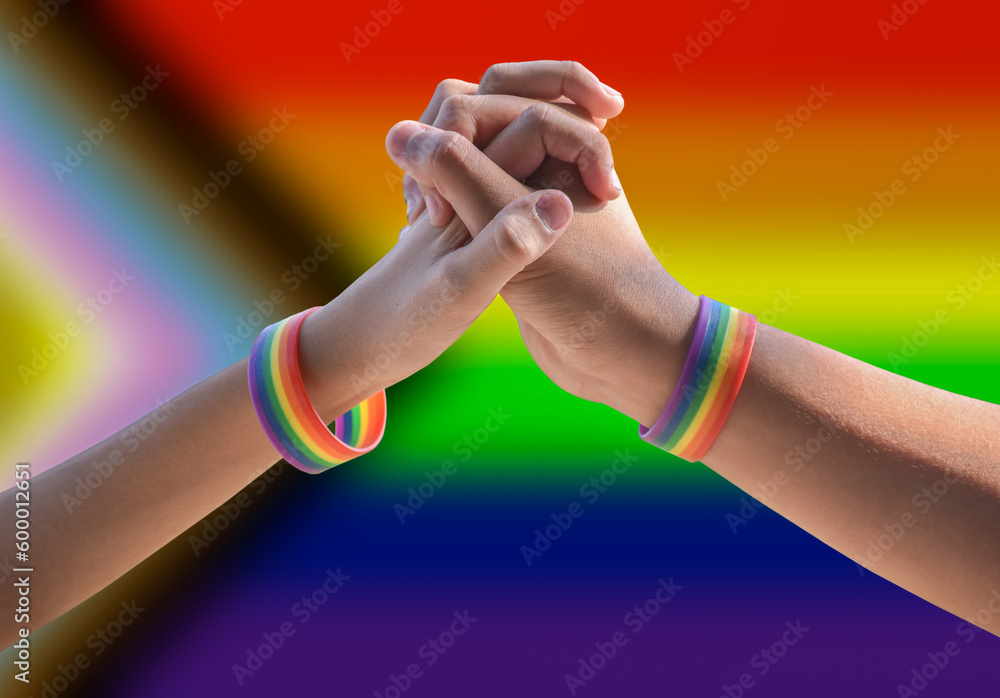 Closeup Hands Of Gay Couple Which Wear Rainbow Wristbands Around With