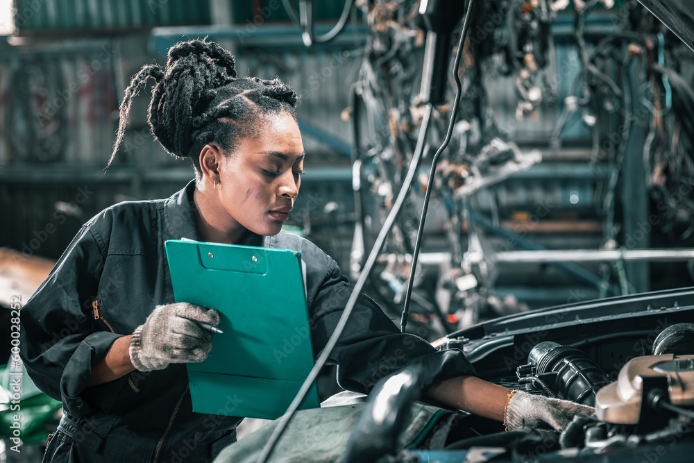 Experienced auto mechanics inspect car battery terminals and voltage to ... Experienced auto mechanics inspect car battery terminals and voltage to ...