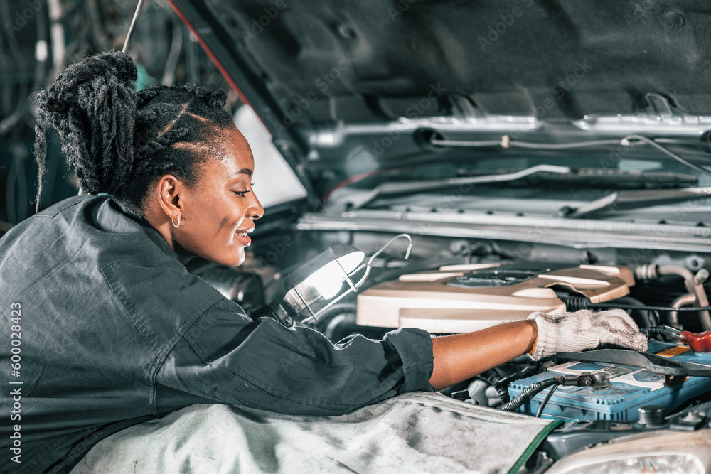 Experienced auto mechanics inspect car battery terminals and voltage to ... Experienced auto mechanics inspect car battery terminals and voltage to ...
