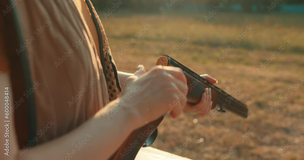 woman holding and reloading the rifle gun cropped video. girl loads ...