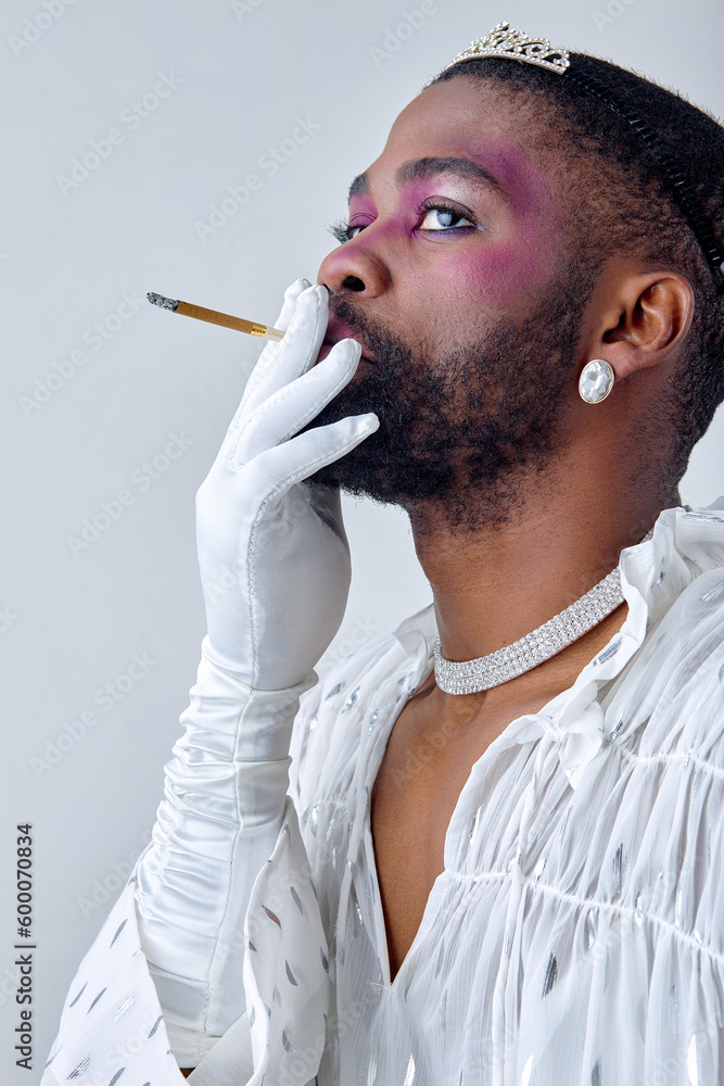 Cool transgender with bright night party makeup smoking cigarette ...