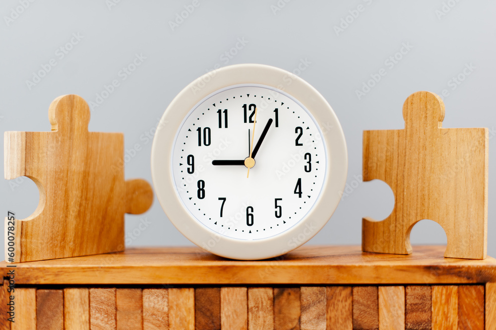Clock next to the jigsaw puzzle piece working against time concept of ...