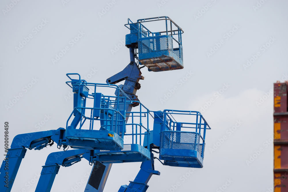 Lift buckets machine against blue sky. Mobile construction crane for ...
