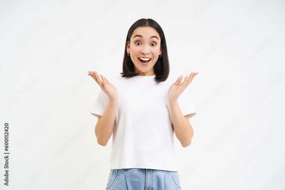 Enthusiastic asian woma, clap hands and smiles with surprised, happy ...