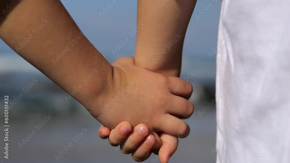 Close up of children's tightly holding hands. Children hold hands on ...