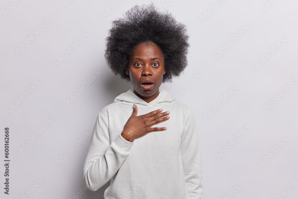 Terrified Afro American woman with bushy hair hears dreadful news keeps ...