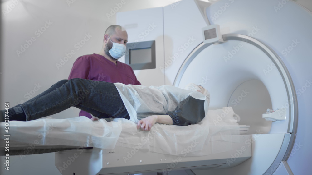 Fotka „The doctor conducts an MRI or PET scan of a patient in a modern ...