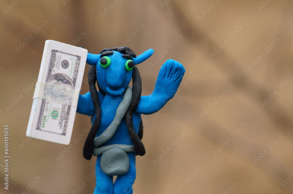 A figurine of a character from the movie avatar with a banknote in his ...