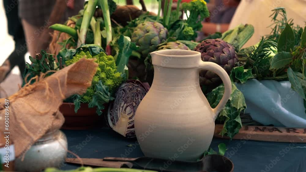Reenactment of medieval times and peasants in village camp, table under ...