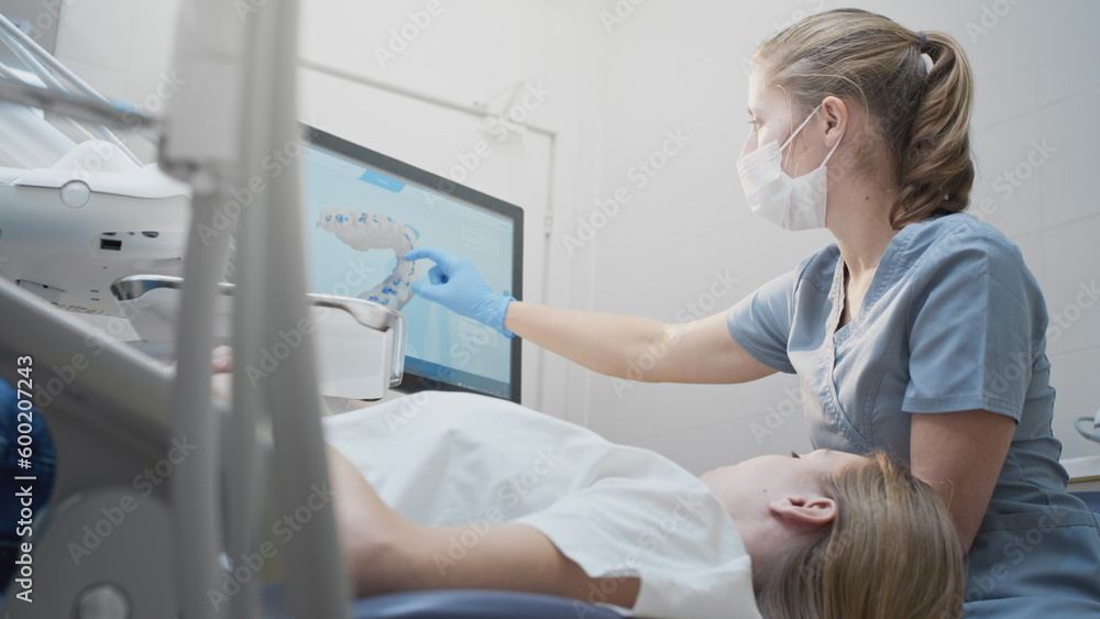 Doctor scans the patient's teeth in the clinic. The dentist holds in ...
