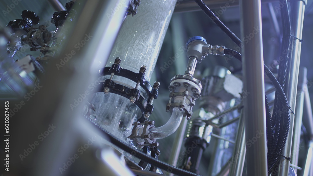 Water pump and pipes. Transparent pipe to show water flows inside the ...