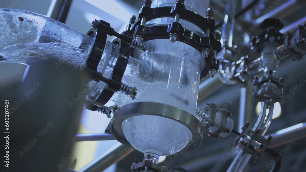 Water pump and pipes. Transparent pipe to show water flows inside the ...