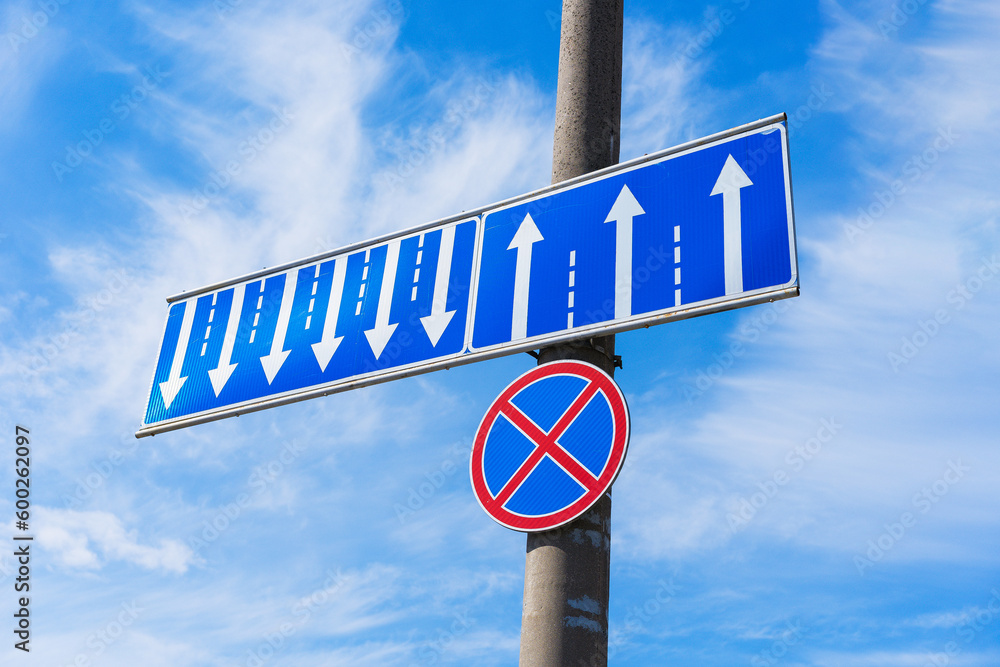 A traffic sign prohibiting car parking (red cross on blue circle) with ...