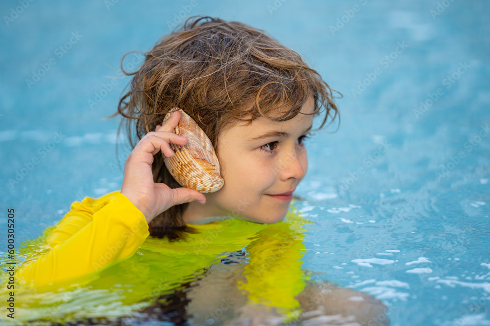 Kid listening to the ocean in a shell. Little boy holding a seashell ...