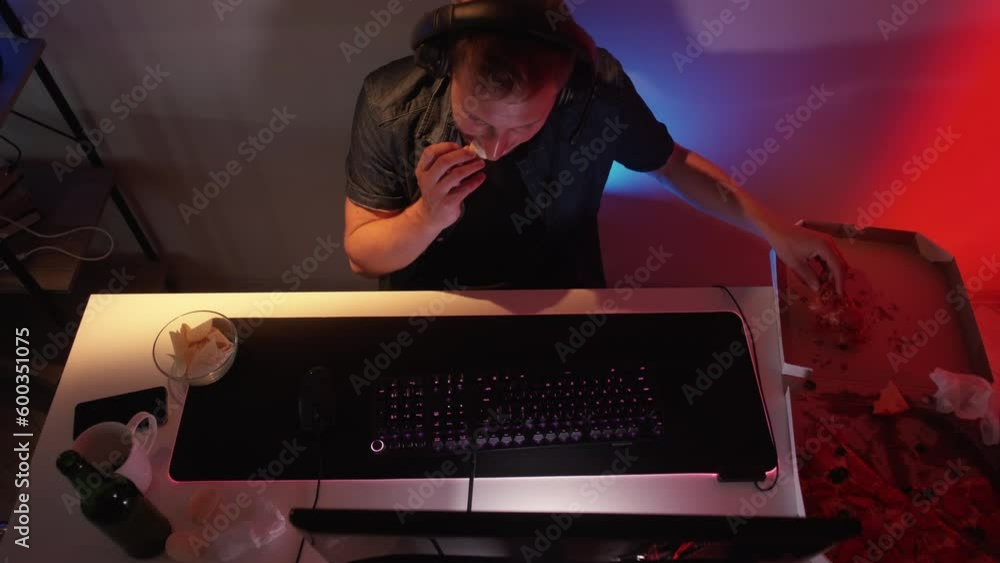 Vidéo Stock Gaming addiction. Junk food. Gamer lifestyle. Hungry guy in ...
