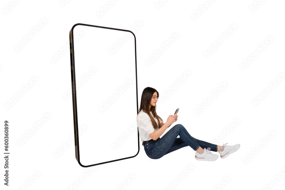 Big smartphone, caucasian girl sitting floor with phone on her hand and ...