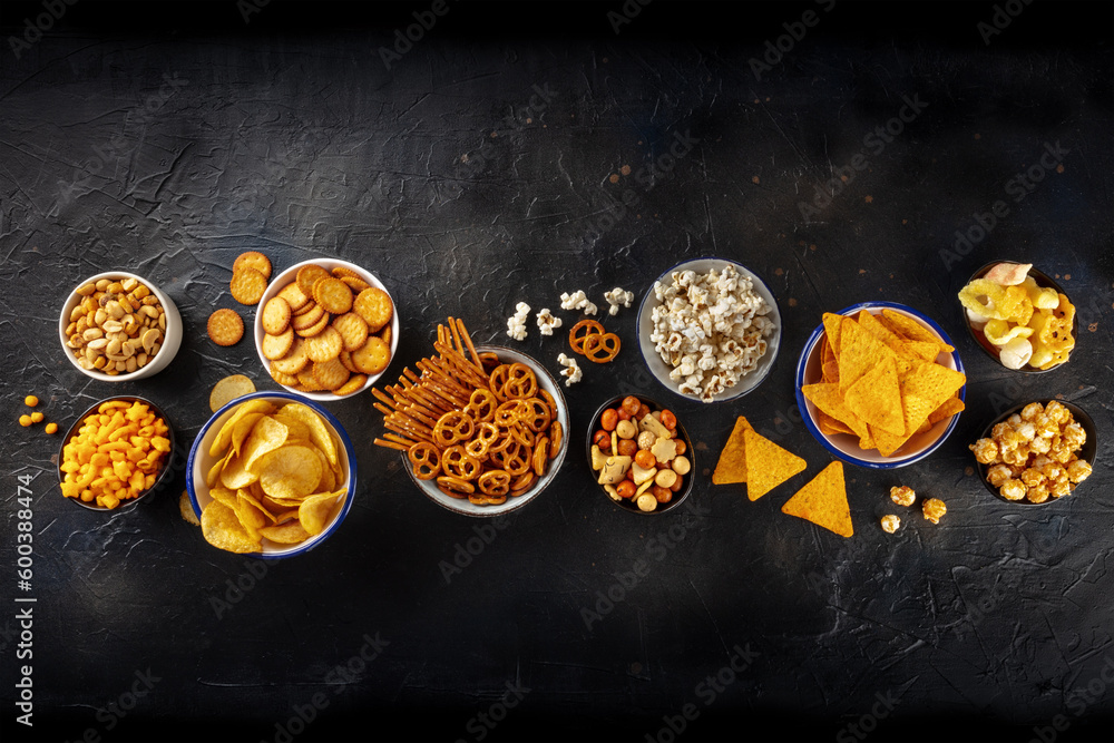 Salty snacks, party mix. An assortment of crispy appetizers, shot from ...