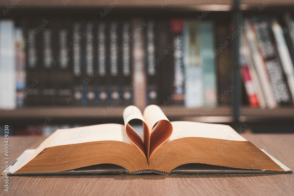 Love read a book with open page of literature in heart shape and stack ...