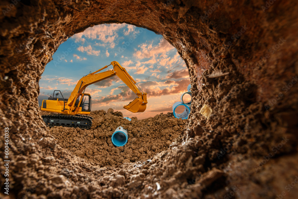 Crawler excavators digging water pipes at construction site and lift up ...