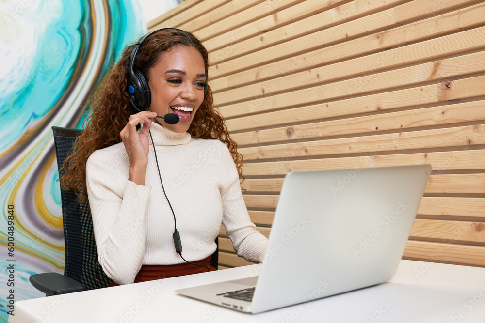 Beautiful young call centre agent smiles in private modern office ...