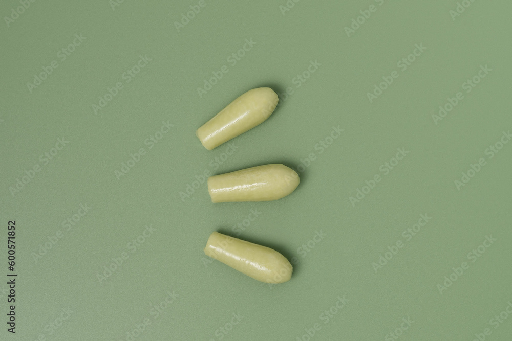 Group of green rectal suppositories for anal or vaginal use on isolated ...