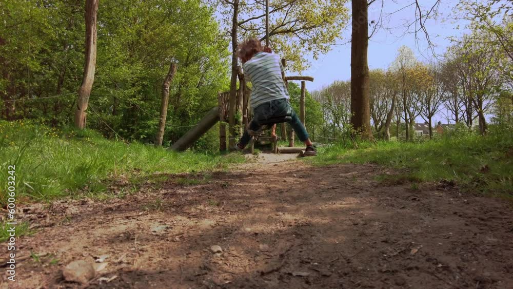 Video Stock Two happy children enjoy playing in the nature playground ...