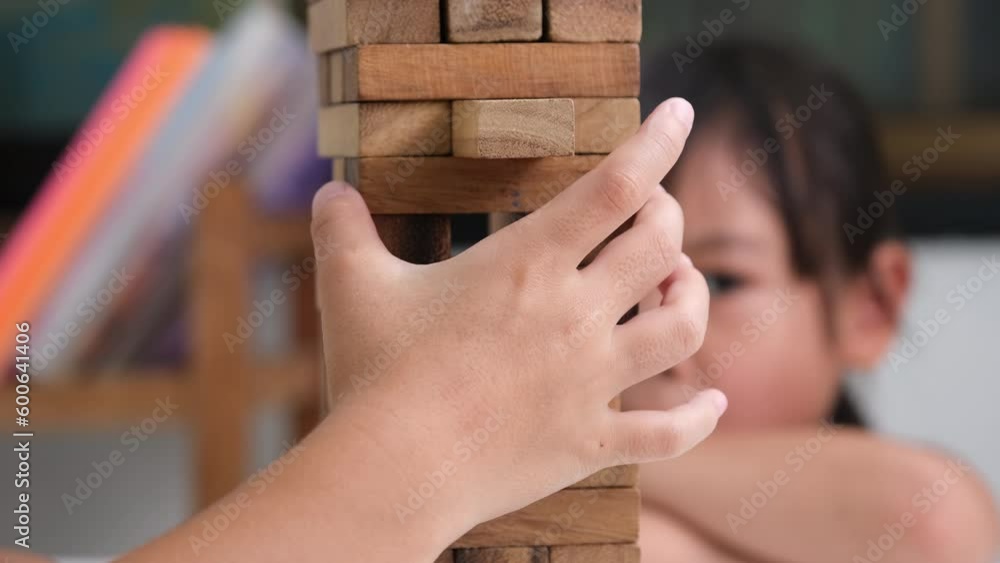 Cute Asian siblings having fun playing Jenga together. Two children ...