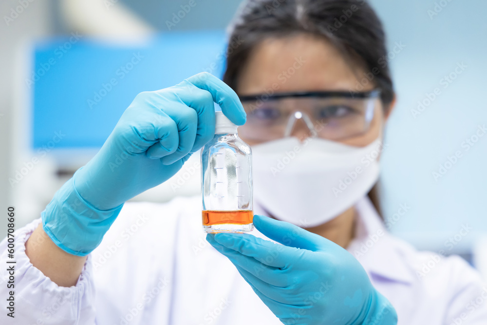 Professional scientist holding solution bottle for test coliform or ...