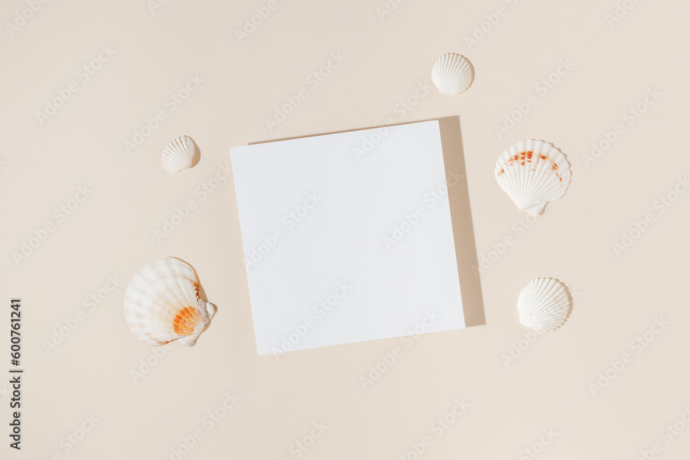 Empty paper sheet card with seashells and shadows on neutral beige ...