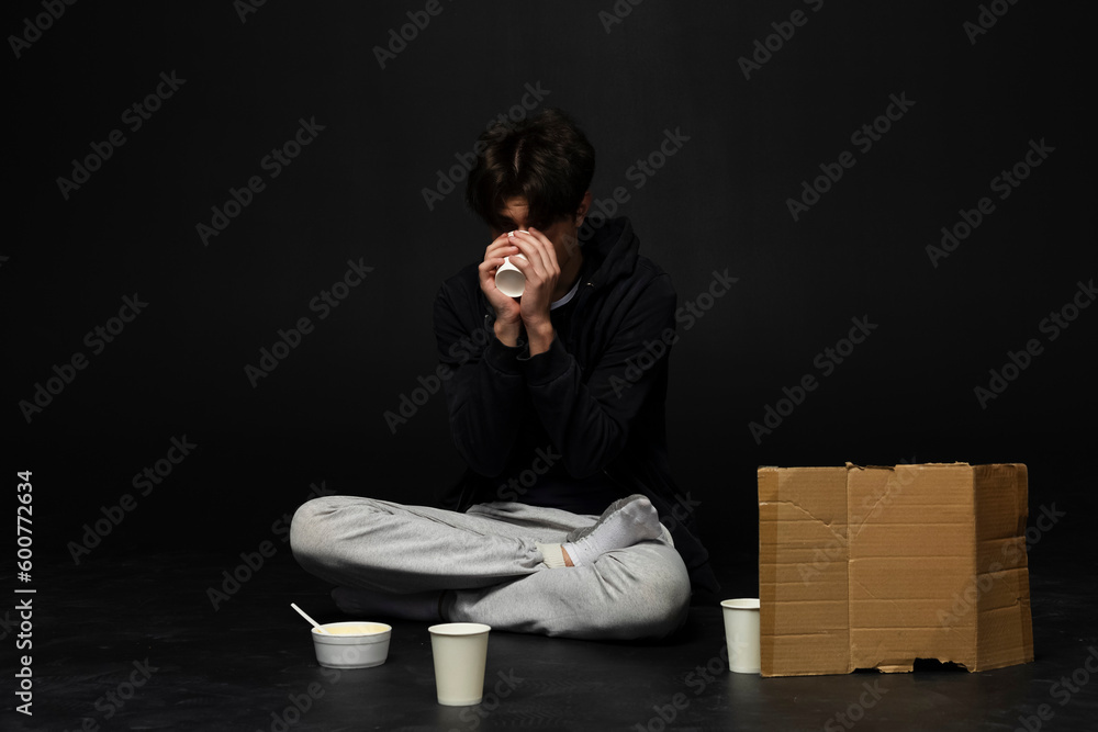 A homeless young person with bruises under their eyes in dirty ...